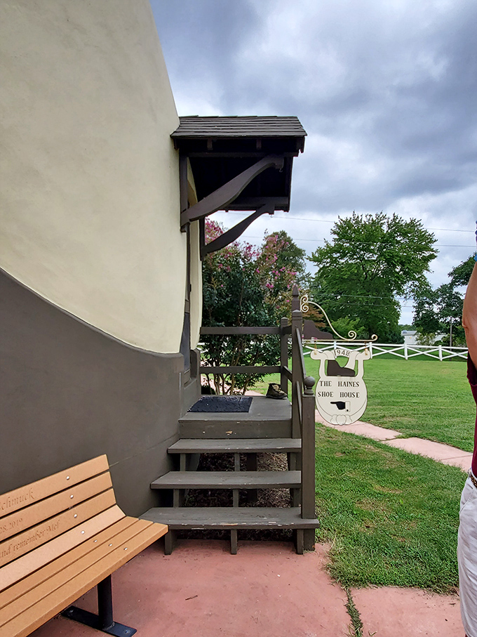 The entrance beckons with its quirky charm. That wooden bench is perfect for contemplating life's big questions, like "Who builds a house shaped like footwear?"