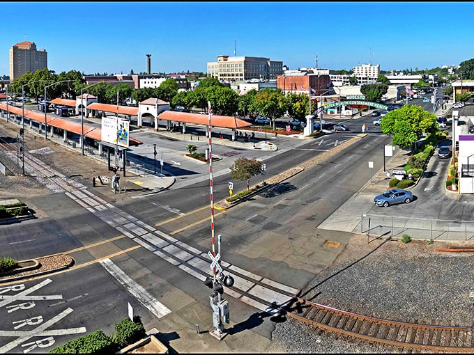 A bird's-eye view of downtown Modesto reveals the city's orderly grid layout, tree-lined streets, and the railroad tracks that helped establish this agricultural hub.