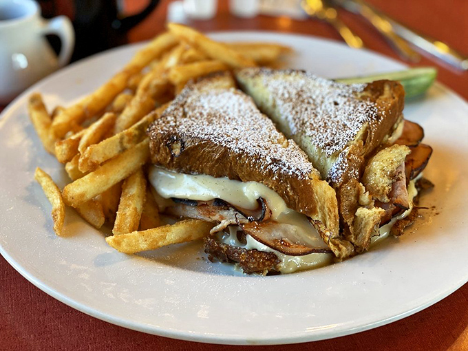The Monte Cristo sandwich: where powdered sugar and savory fillings have a delicious identity crisis. Those fries are just showing off.