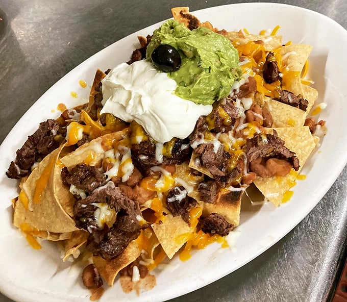 Nachos that don't mess around: loaded with beef, beans, cheese, and topped with the holy trinity of sour cream, guacamole, and olives.