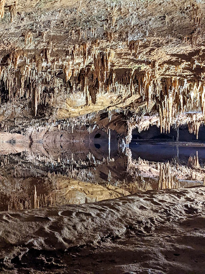 The perfect mirror reflection in Rainbow Lake doubles the visual impact, creating a symmetry that seems almost too perfect to be natural.