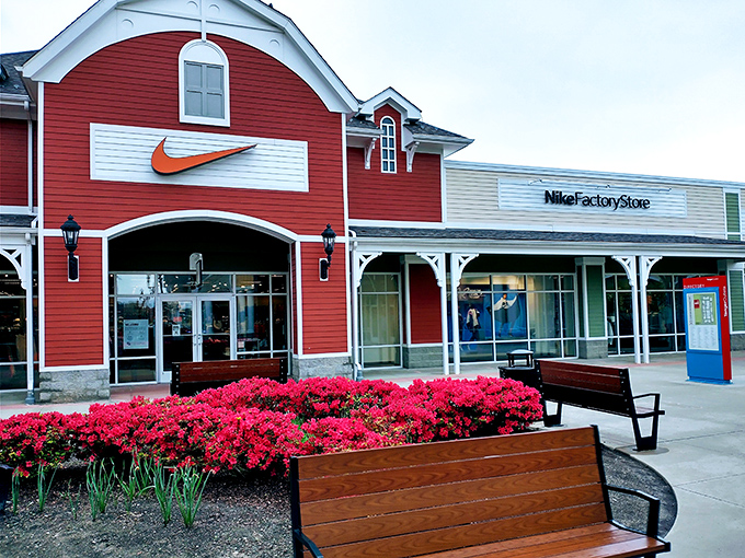 Nike's vibrant storefront, framed by blooming azaleas, proves that even athletic wear shopping can be a visually stunning experience.