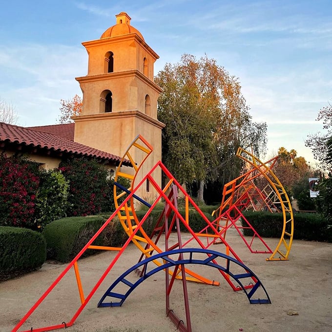 The Ojai Valley Museum's bell tower glows golden in late afternoon light, while colorful playground sculptures add whimsy to this cultural landmark.