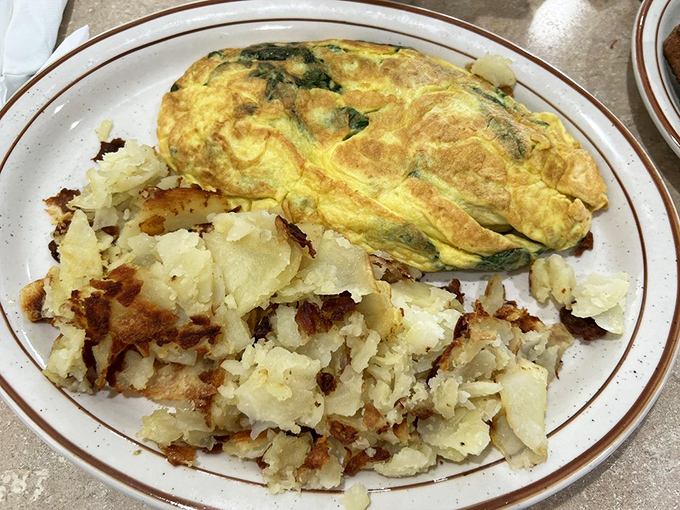 The perfect omelet—golden outside, tender inside—paired with crispy hash browns. Breakfast doesn't get more honest or satisfying than this.