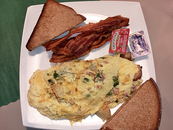 The breakfast trinity: a perfectly executed omelet, bacon cooked to that magical point between chewy and crisp, and toast standing by for yolk-sopping duty.