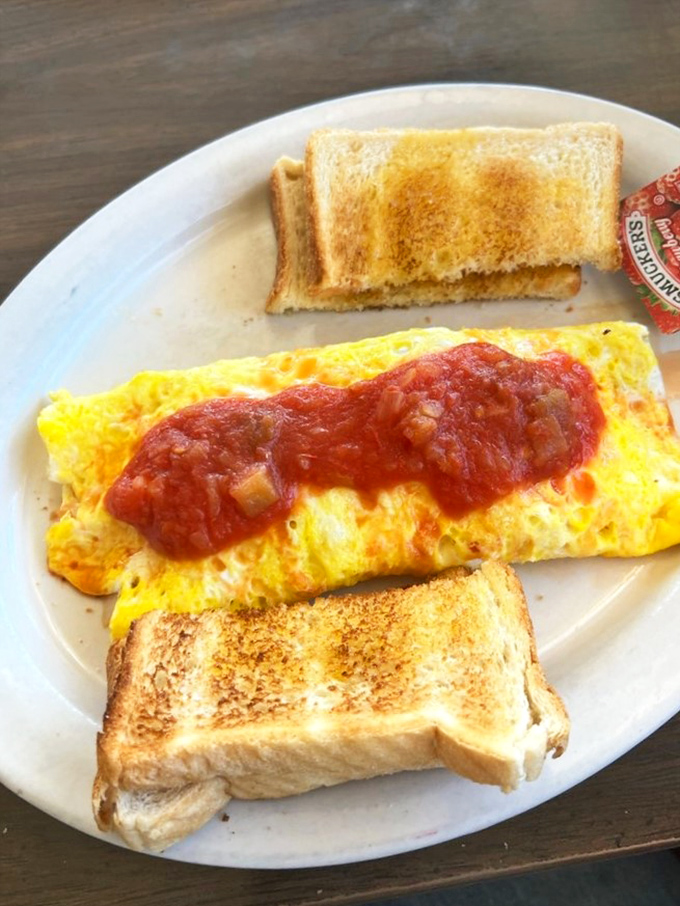The perfect omelet &ndash; sunshine yellow and stuffed with goodness, flanked by toast soldiers ready for their delicious mission.