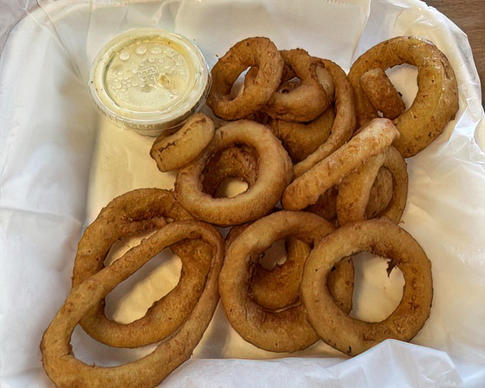 Onion rings that understand the importance of proper batter-to-onion architecture. Crispy, golden hoops of happiness served with no apologies.