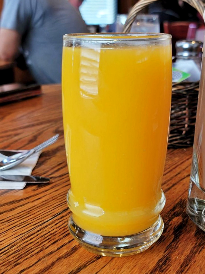 Fresh-squeezed orange juice so vibrant it looks like liquid sunshine – the perfect companion to whatever breakfast masterpiece you've ordered.