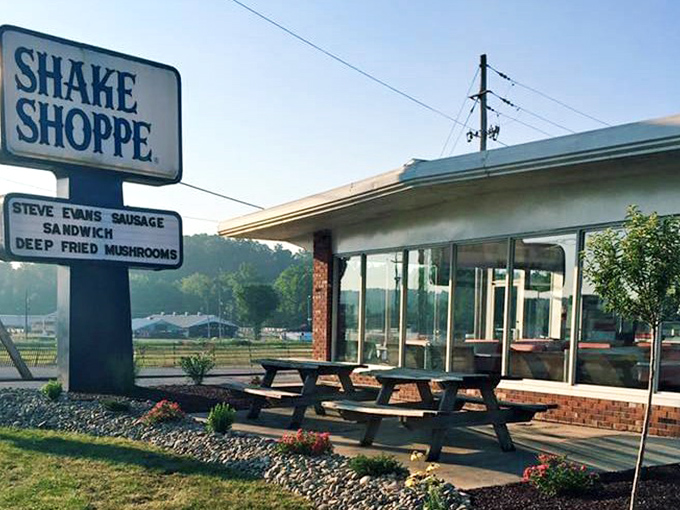 The picnic tables outside offer al fresco dining with a side of small-town charm. That sign could guide hungry travelers from miles away.