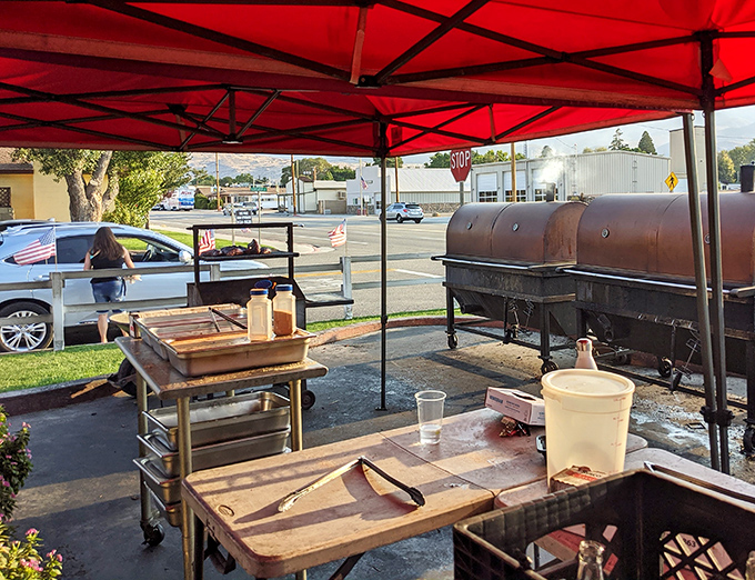 Under the red tent, barbecue alchemy happens. Those smokers aren't just cooking equipment &ndash; they're time machines to flavor country.