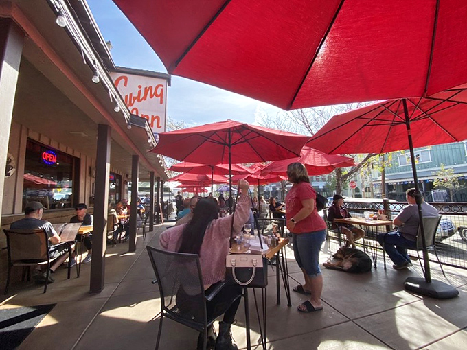 The outdoor patio where Temecula sunshine meets BBQ satisfaction under a canopy of cheerful red umbrellas.