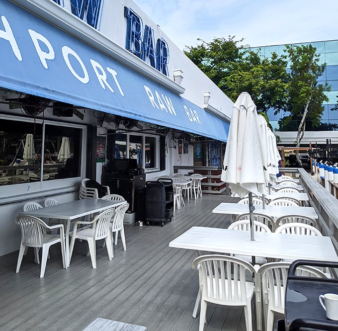 The waterfront deck where time slows down and appetites grow. White tables against blue waters&mdash;Florida's natural color palette at work.