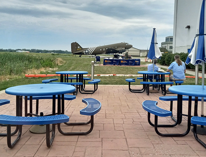Outdoor dining with a vintage aircraft backdrop &ndash; because breakfast should always include adventure.