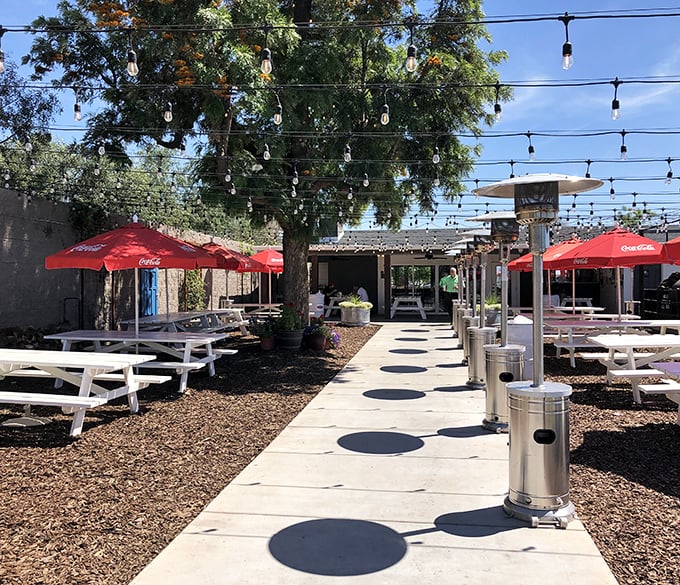 The outdoor patio strings lights overhead like stars, creating an al fresco dining experience that perfectly complements Arizona evenings.