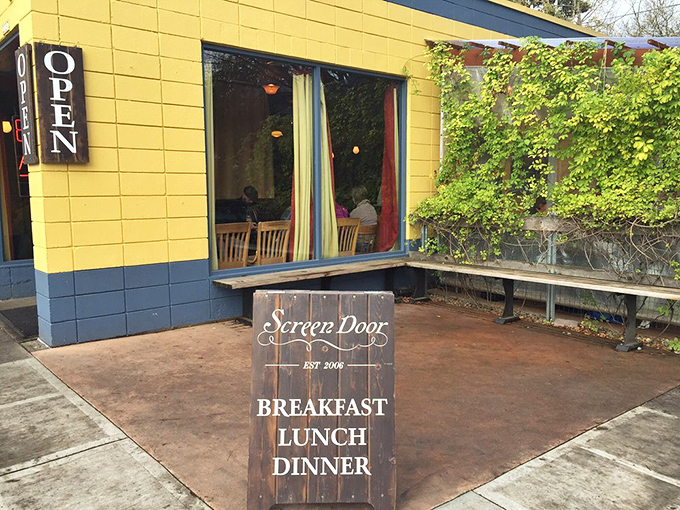 The cheerful yellow exterior and wooden sign invite passersby to stop for a meal that'll become a memory.