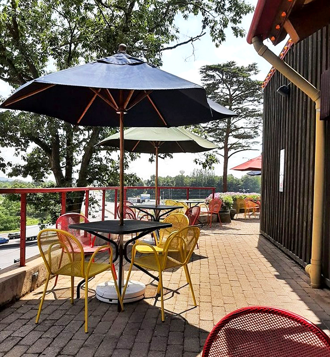 Colorful outdoor seating that says "stay awhile." Those yellow chairs are practically begging you to linger over one more helping of brisket.