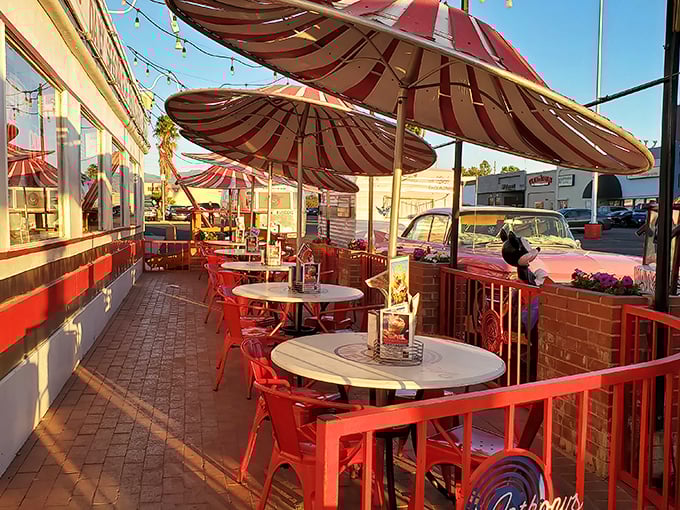 The outdoor patio where Arizona sunshine meets cherry-red tables, proving that some dining experiences deserve their moment in the sun.