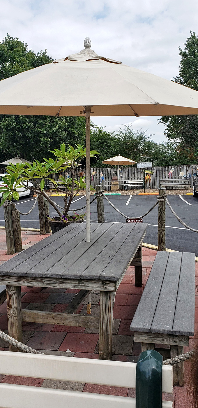 Rustic outdoor seating under beach umbrellas &ndash; where burger bliss meets fresh air in perfect harmony.
