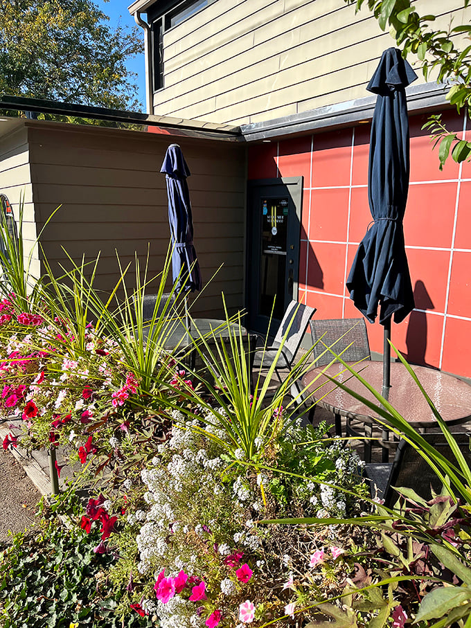 The outdoor patio blooms with flowers almost as colorful as the conversations happening around the tables. Nature's dining room with a side of sunshine.