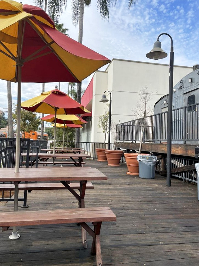 The outdoor seating area, with its red and yellow umbrellas, offers a perfect spot to enjoy your burger while watching the Studio City world go by.