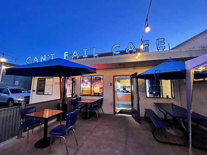 As night falls, the neon "CAN'T FAIL CAFE" sign becomes a beacon for the hungry, the sleepless, and those who appreciate a good late-night hash brown.