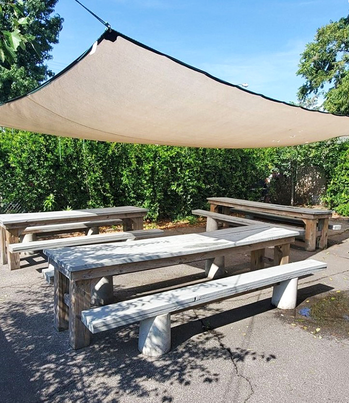 The outdoor dining area: where vitamin D meets vitamin Delicious under a canopy that's seen countless food-induced smiles.