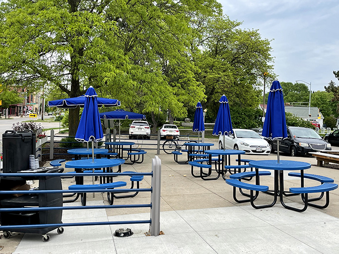 Outdoor dining with a distinctly Wisconsin touch &ndash; those blue umbrellas have sheltered countless conversations over coffee and pie throughout Madison's seasons.