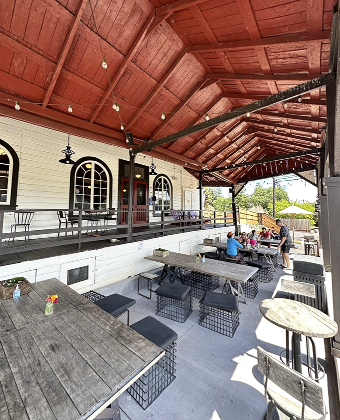 The covered patio provides shade for serious sandwich contemplation, where the only acceptable interruption is asking, "Can I try a bite of yours?"