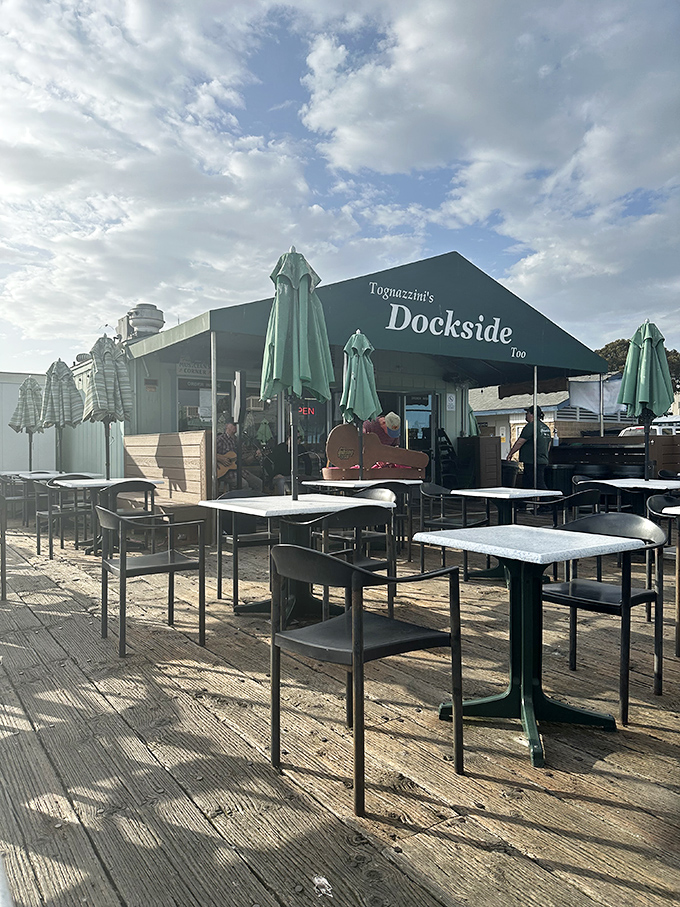 Morning sunshine illuminates empty tables that won't stay that way for long. Early birds get the best harbor views.