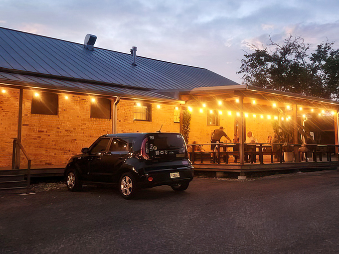 Evening transforms the patio into a magical dining destination where pizza and conversation flow freely together.