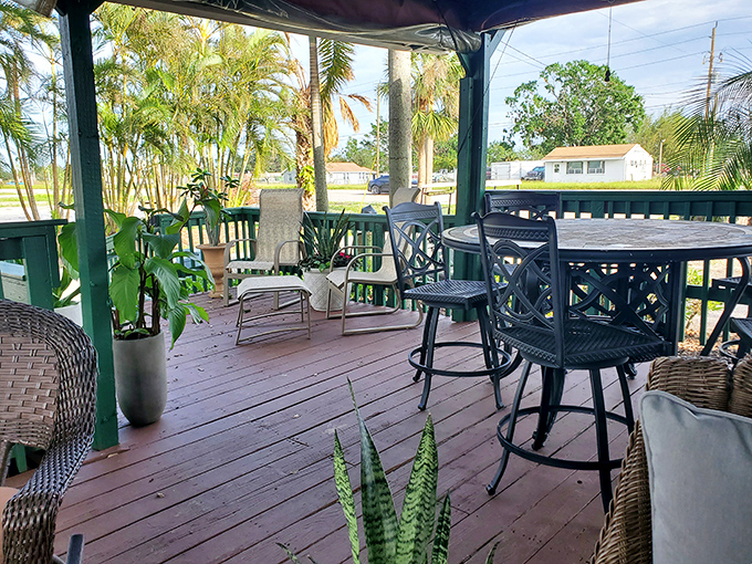 The outdoor patio offers a lush tropical escape. Palm fronds provide nature's ceiling fan while you digest your seafood feast.