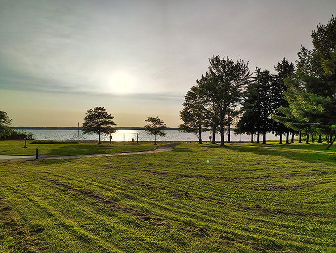 Freshly mowed grass meets tranquil waters under a gentle sun. If peace had a physical address, this view would be on its mailbox.
