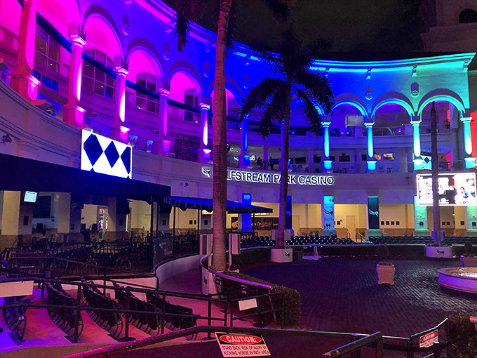 By night, Gulfstream Park transforms into a neon wonderland, where even the architecture gets dressed up for a night out.