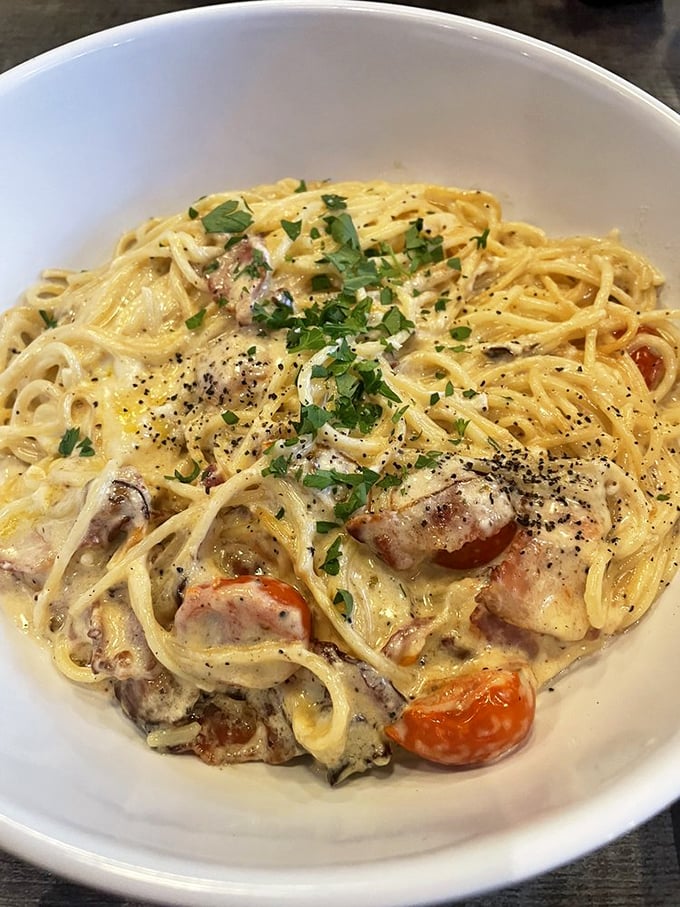 Carbonara that's achieved the pasta dream&mdash;each strand perfectly coated in silky sauce with cherry tomatoes providing bright counterpoints to richness.