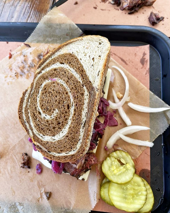 A sandwich that requires both hands and a strategy&mdash;marble rye spirals holding a mountain of meat that's worth every napkin you'll need.