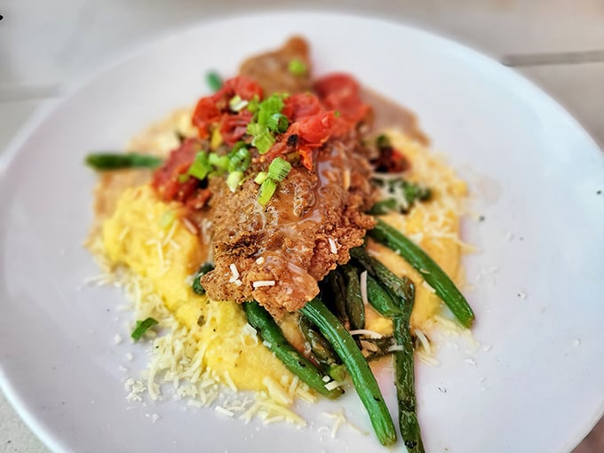 This isn't just fish&mdash;it's a Southern sonnet on a plate, with crispy pecan crust playing harmony to creamy grits and vibrant vegetables.