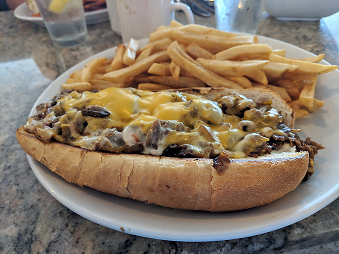 This cheesesteak sandwich isn't just lunch&mdash;it's an edible hug. Those fries are standing by, ready for their supporting role.