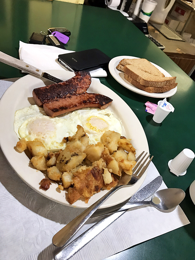 Polish sausage bringing its A-game to breakfast, flanked by eggs and potatoes in a trinity of morning satisfaction.