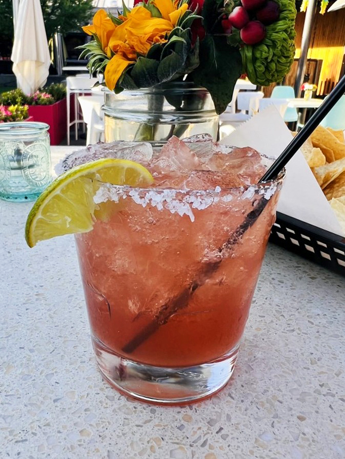 This pomegranate margarita looks like liquid sunset and tastes like Arizona captured in a perfectly salted glass..