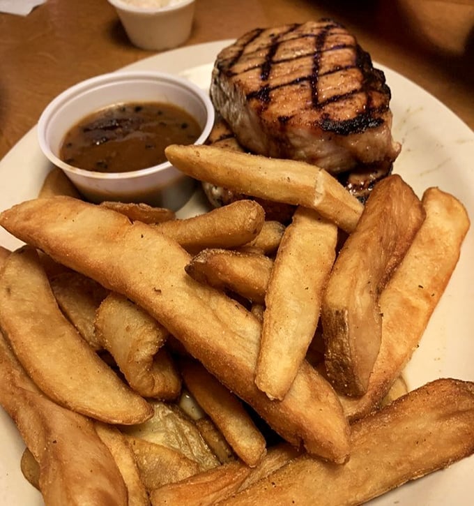 Juicy pork chop with perfect grill marks tells you everything you need to know about the kitchen's commitment to proper technique.