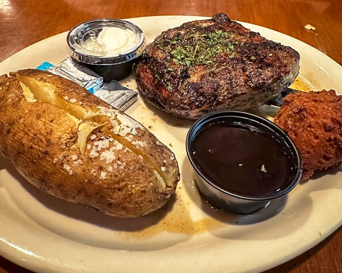 A perfectly seared steak with a baked potato that could feed a small family. This isn't dinner&mdash;it's a celebration of American beef done right.