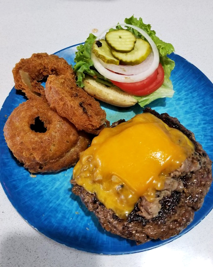 The burger that launched a thousand return visits. Melty cheese, perfectly seared beef, and fresh veggies on a plate that matches the ocean outside.