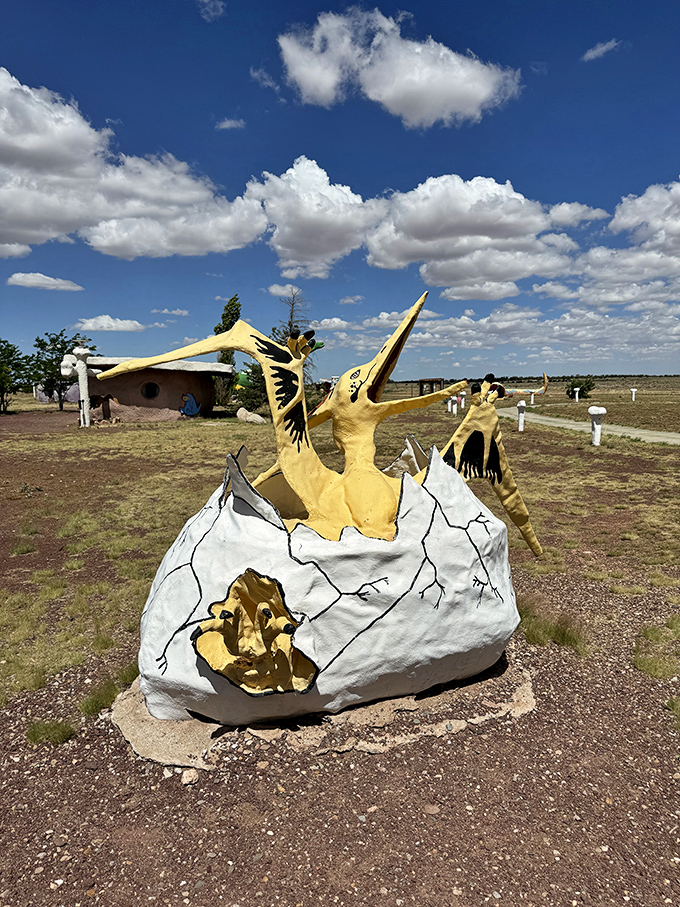 Breaking out of its shell with prehistoric flair, this pterodactyl sculpture captures the moment of birth with cartoonish charm.