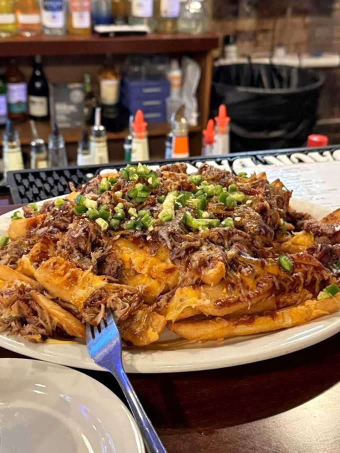Loaded fries that make French cuisine look underdressed&mdash;pulled pork and green onions creating a fork-fighting masterpiece.