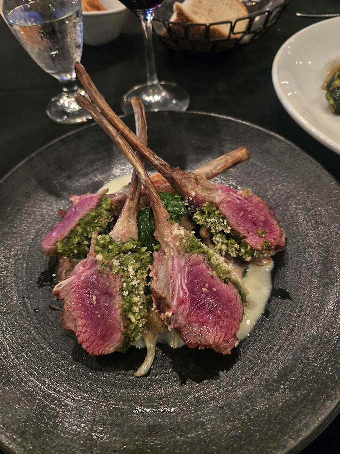 Rack of lamb wearing a verdant herb crust like nature's perfect accessory. This is meat dressed for its own red carpet moment.