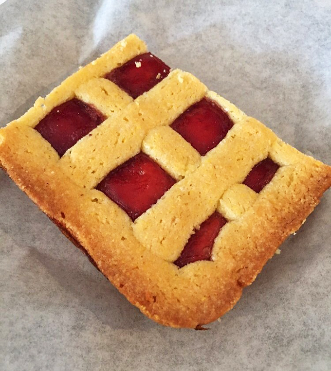 This raspberry tart isn't just dessert – it's edible geometry with a sweet-tart personality. The lattice top practically winks at you.
