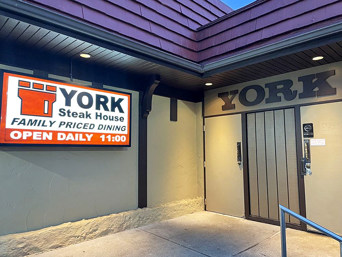 The rear entrance sign promises no pretension&mdash;just follow the arrow to one of Columbus's most enduring dining institutions and prepare for meat-induced happiness.