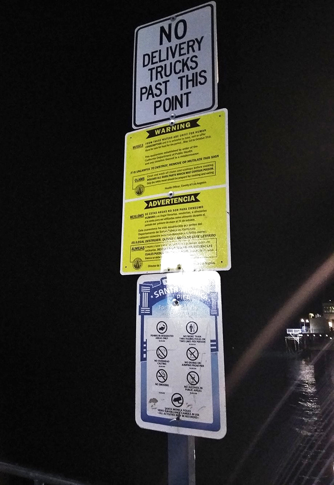 Every warning sign tells a story. Someone, somewhere, once thought delivering trucks on a century-old wooden pier was a good idea.