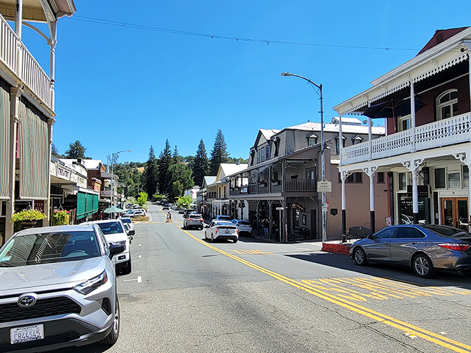 Sunlight bounces off colorful facades as the road curves gently uphill, revealing why this town is often called "the jewel of the Gold Country."