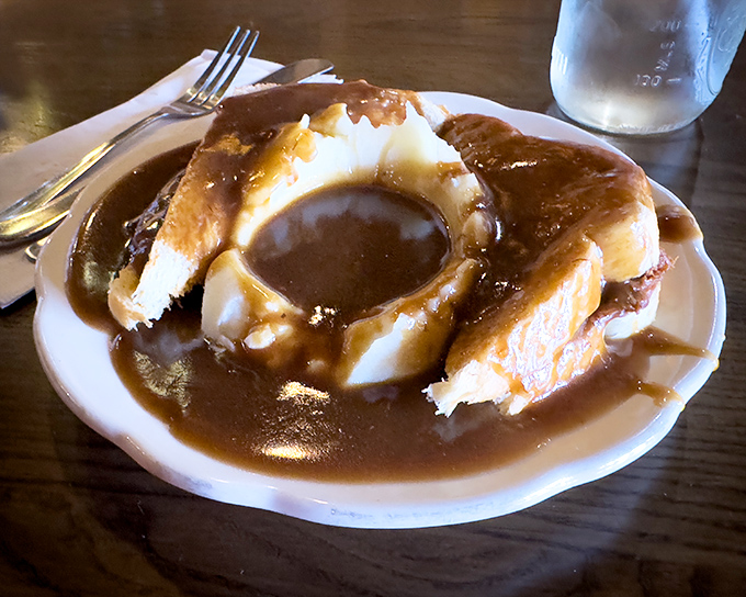 Hot roast beef sandwich swimming in gravy&mdash;where the bread isn't just a delivery system, it's a willing participant in delicious excess.